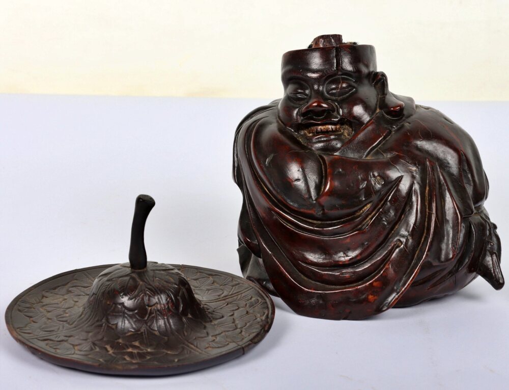 A 19th century bamboo root carved deity with hat