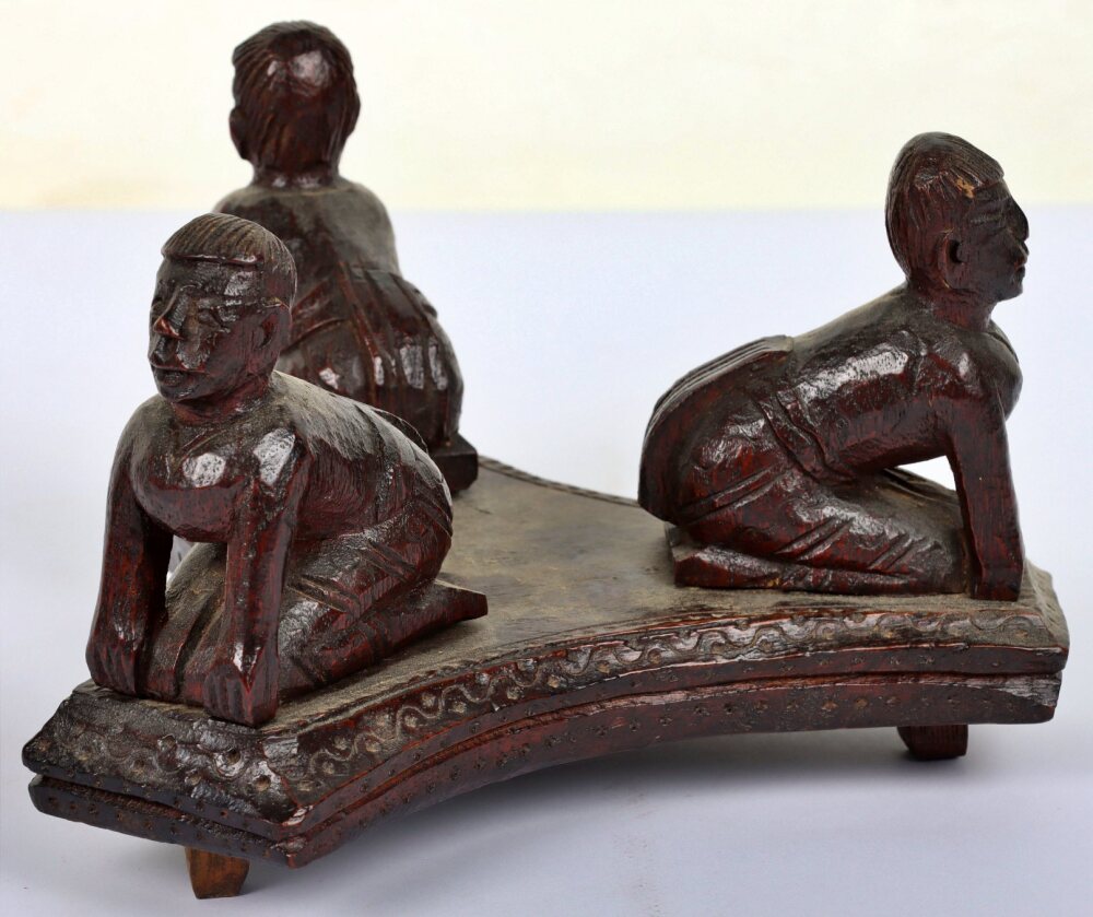 A 19th century bamboo root carved deity with hat