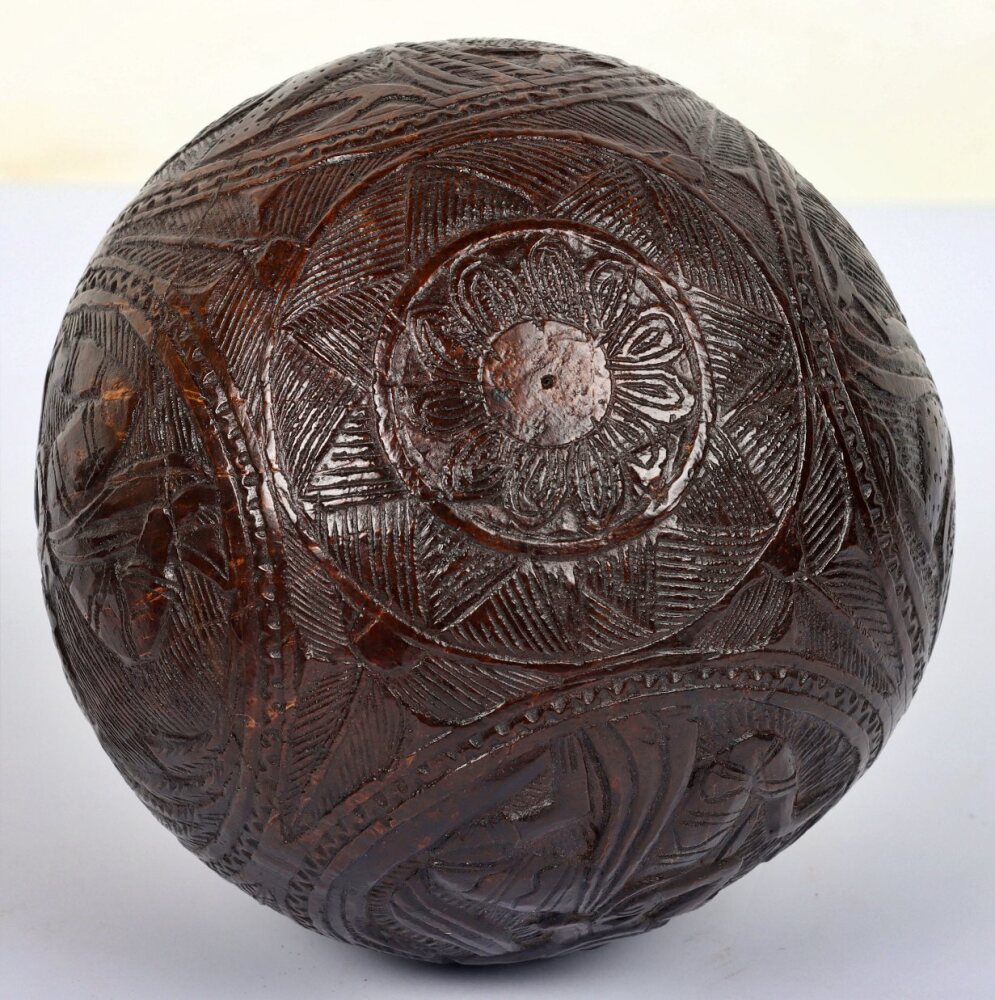 A 19th century bamboo root carved deity with hat