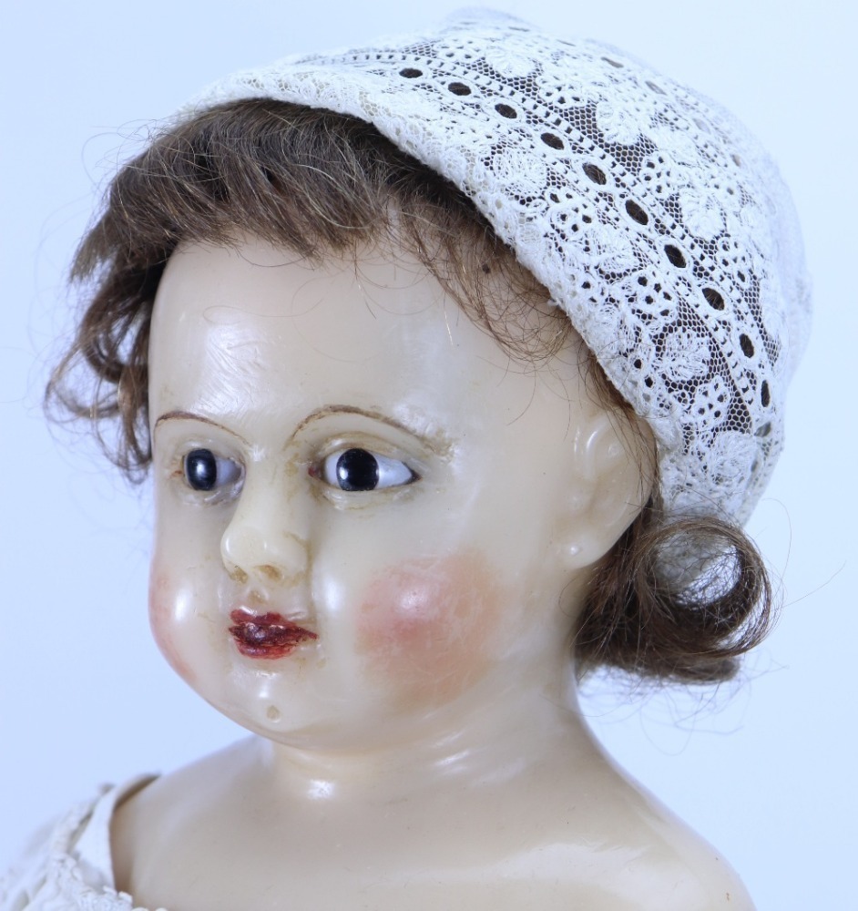A rare early poured wax shoulder head doll with painted teeth, English ...