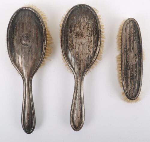 A silver dressing table brush set