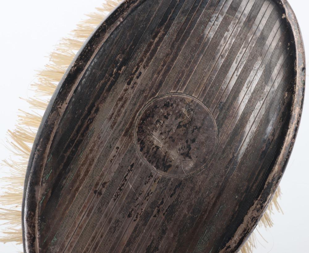 A silver dressing table brush set